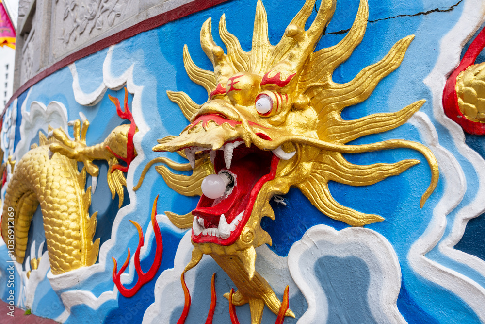 Gold Leaf Dragon head with modern light bulb as seen at Tua Pek Kong ...