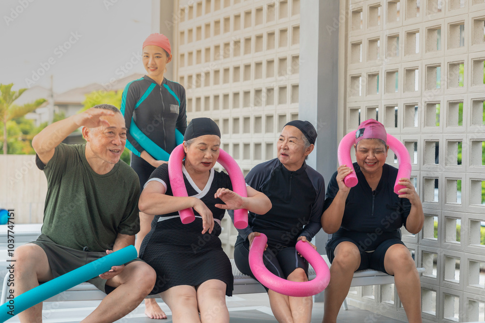 group of joyful seniors participates in a fun water exercise class ...
