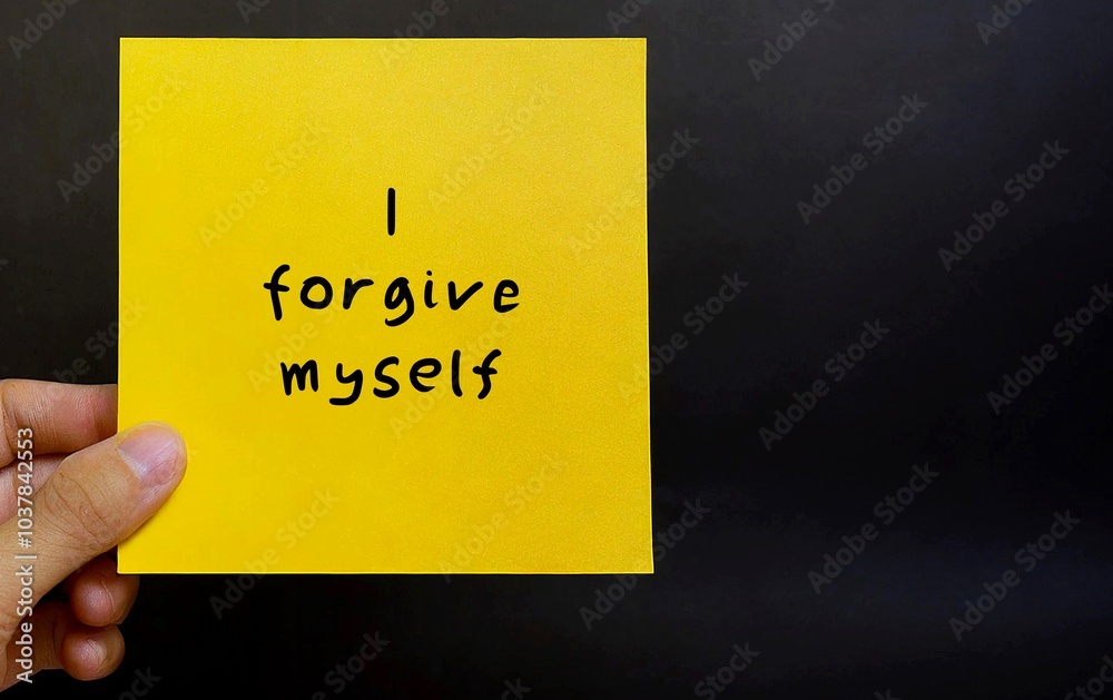Hand holding yellow note on black copy space background with text I ...