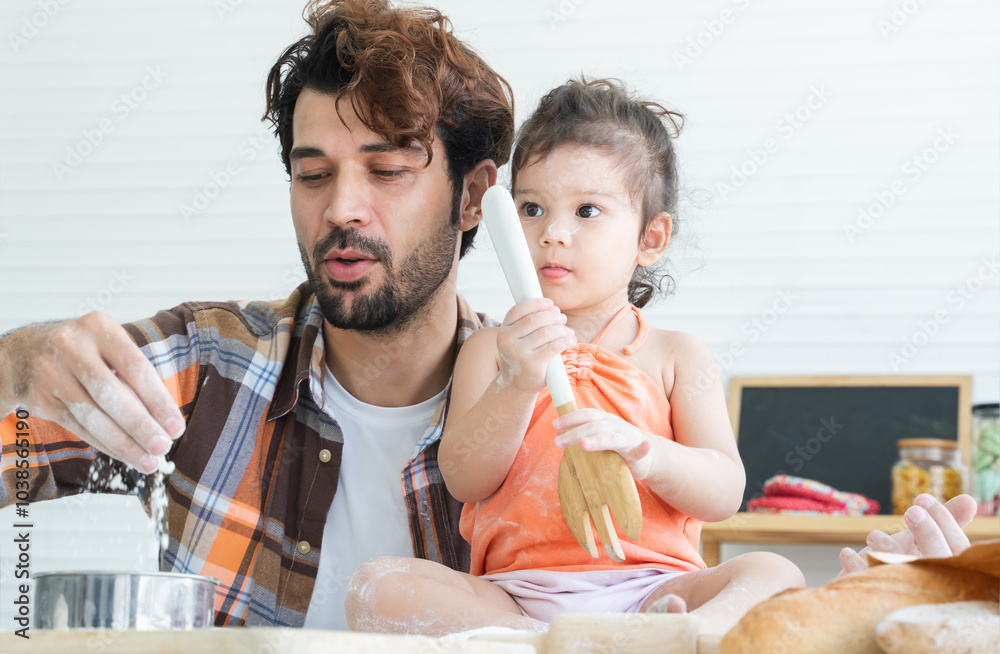 Cute Caucasian family, father smiling and teaching little daughter how ...