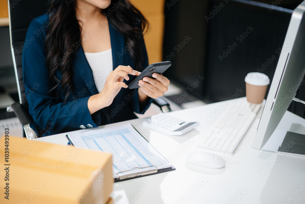 Businesswoman handling packaging and logistics in a modern workspace, managing e-commerce orders ...