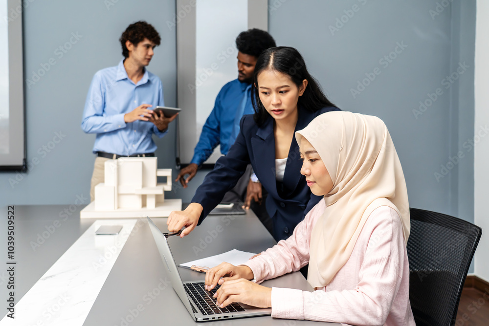 Asian and Muslim women working together on a laptop, With a background ...