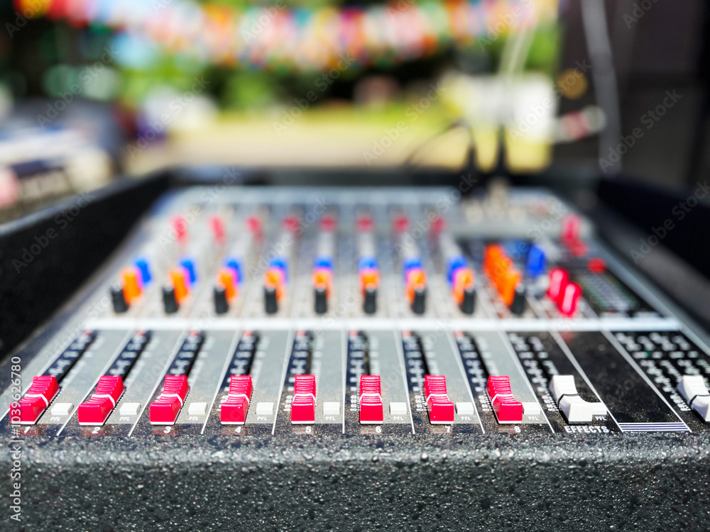 audio mixer soundboard. The mixing console features several rows of ...