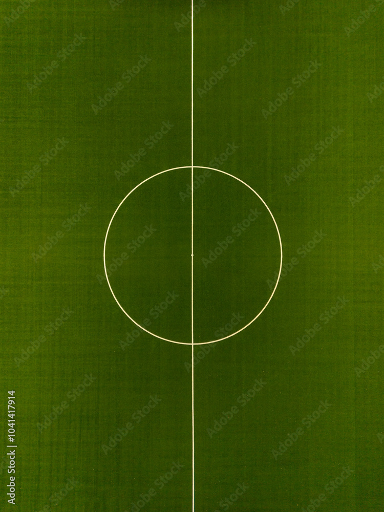 Green grass and white lines. Aerial closeup of the midfield circle in ...