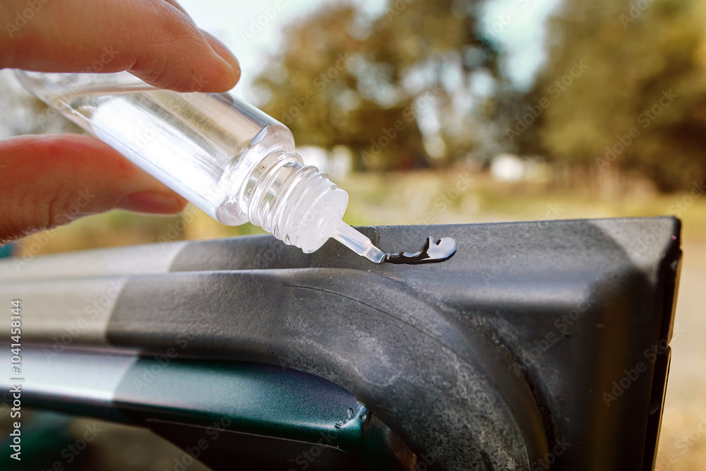 Applying silicone lubricant on car window rubber seal to protect from ...