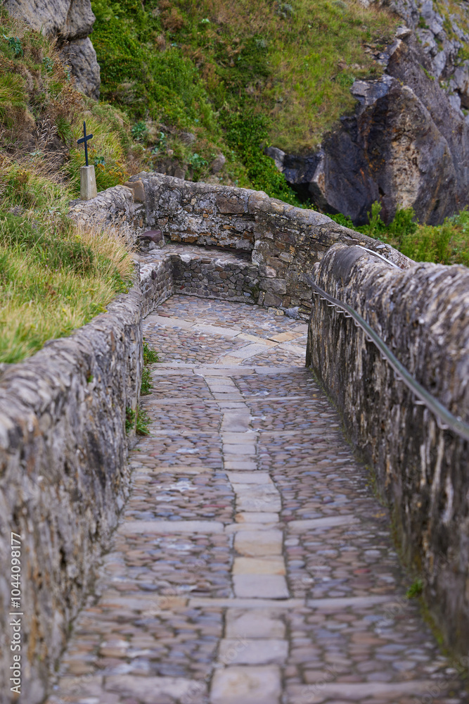 Way of Sorrowss on a stairs on Gaztelugatxe island with famous San Juan ...