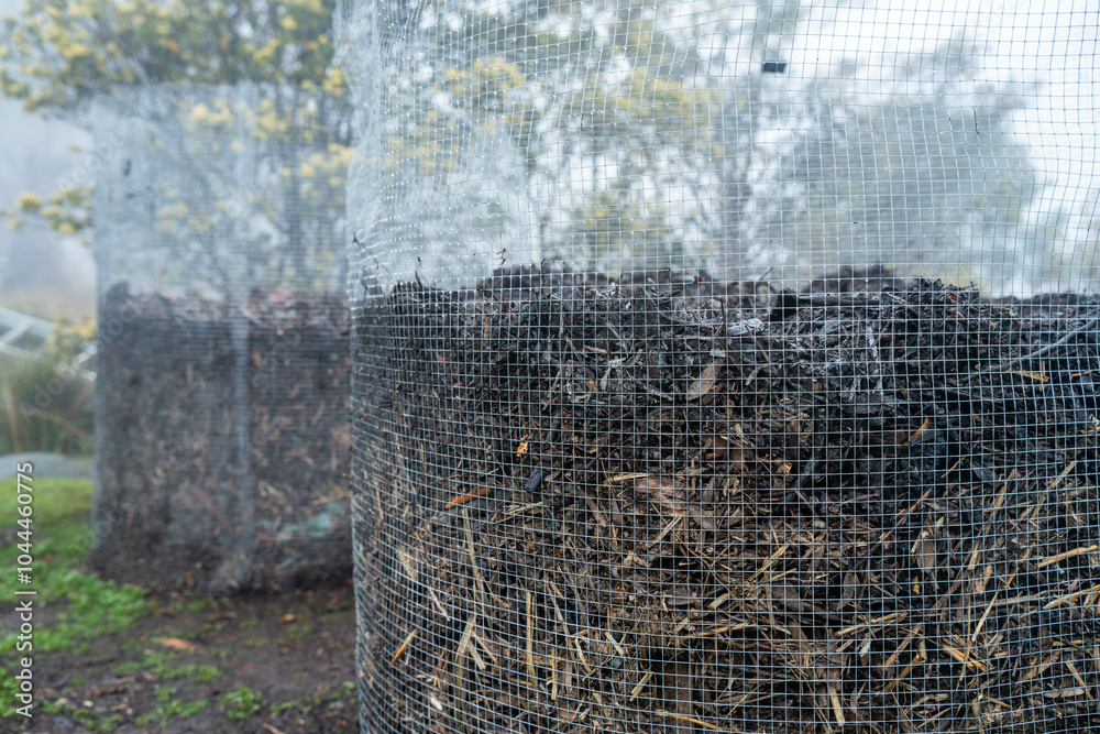 turning a compost pile in a community garden. compost full of ...