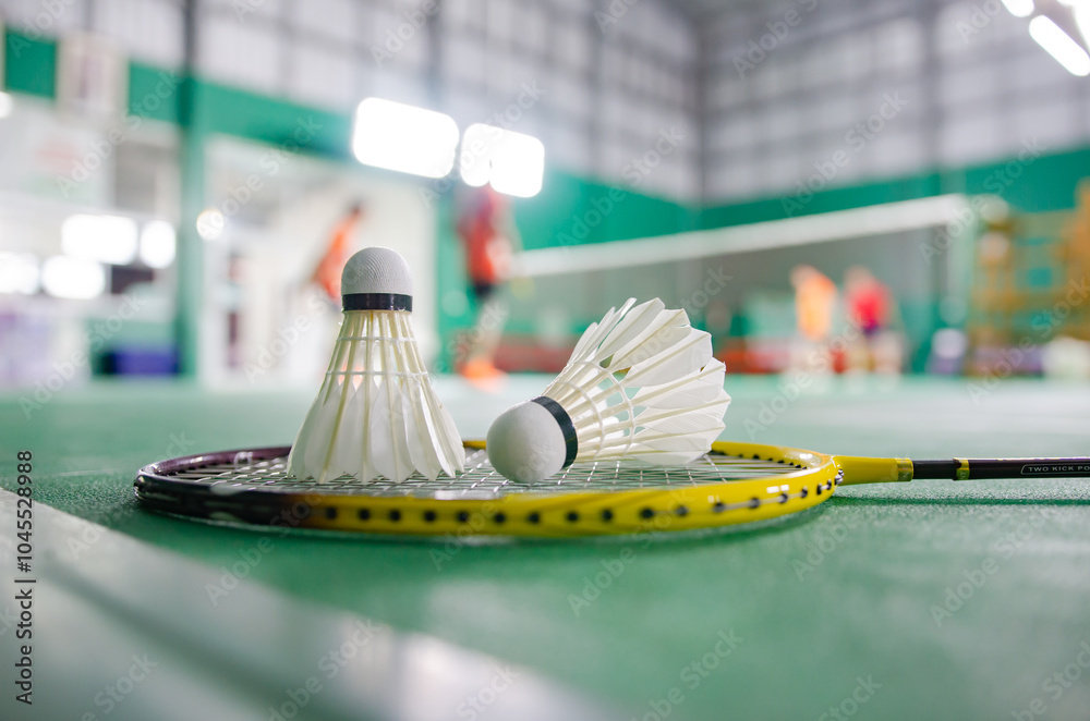 Badminton rackets and white cream badminton shuttlecocks after playing ...