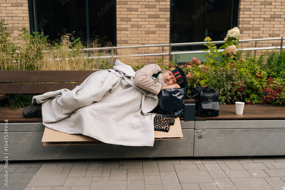 Lone homeless mature male resting on city bench, symbolizing hardships ...