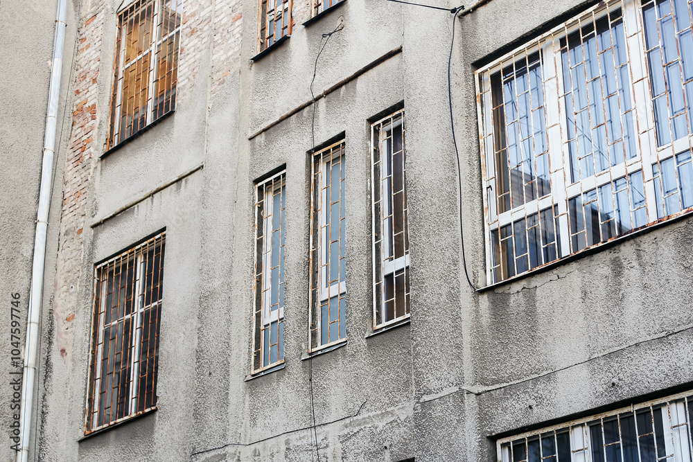 Old abandoned factory building with rusted barred windows. Industrial ...