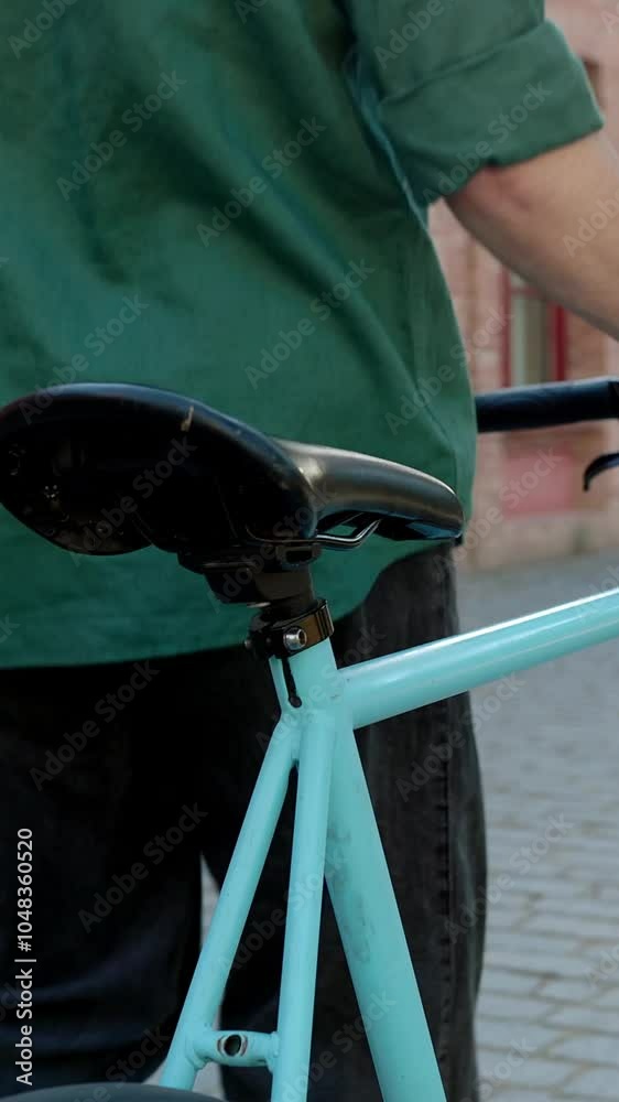 Rear view vertical HD video of young man pushing urban bicycle at city ...