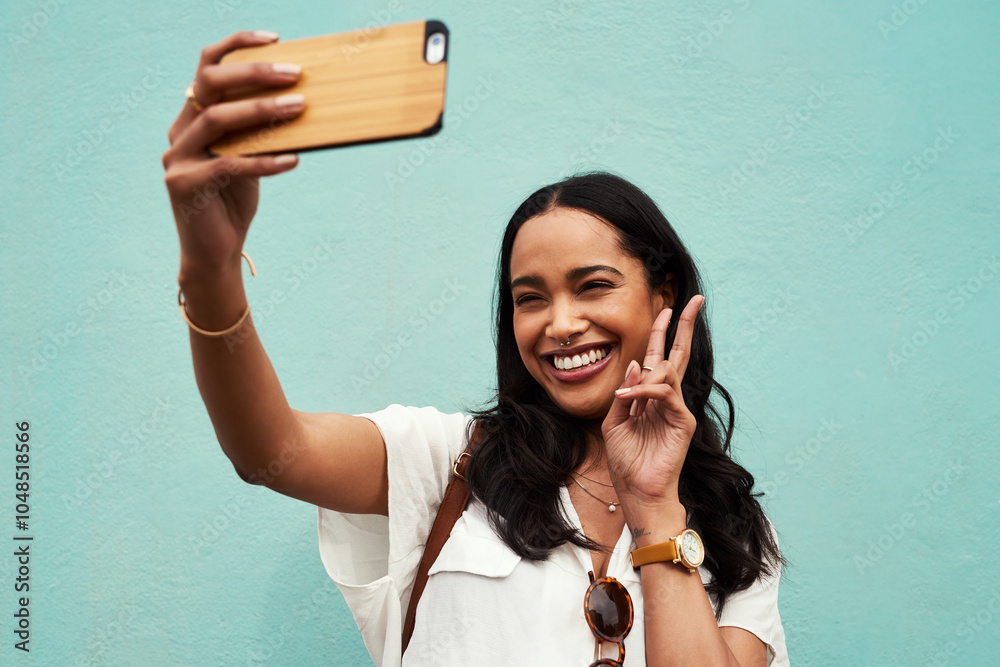 Selfie, blue background and woman with peace sign in city for social ...