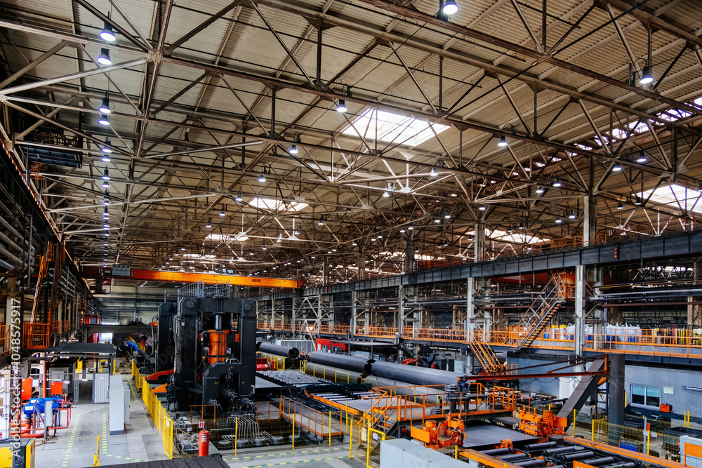 Pipe factory production line. Tube formation by roll sheet bending ...