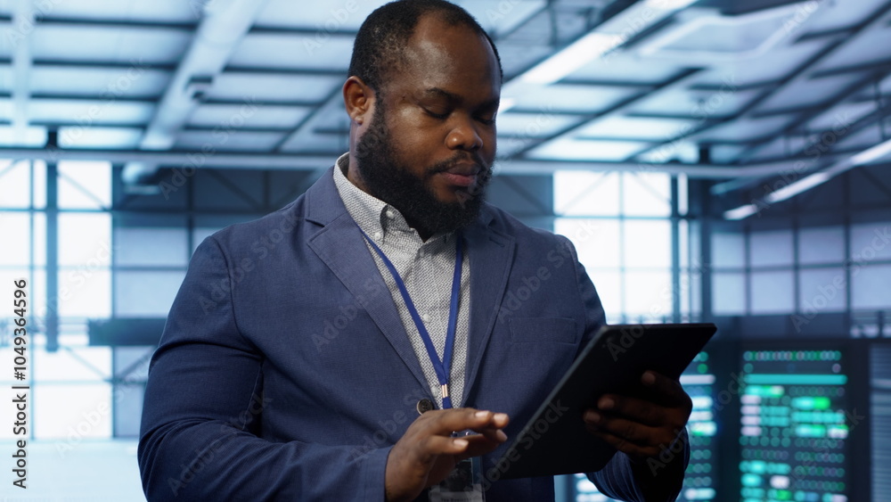 IT technician walking in data center, overseeing server operations ...