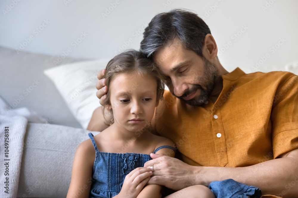 Depressed middle aged father with closed eyes hugging sad little ...