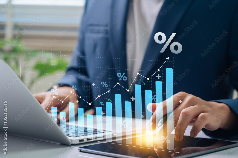 A business professional examines a digital financial chart displaying ...
