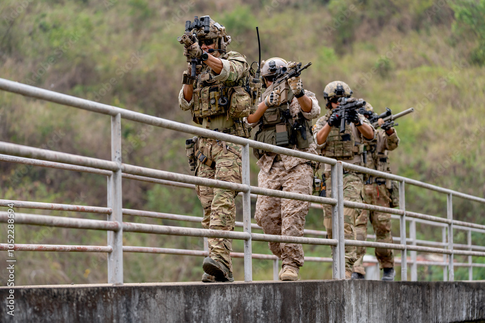 Group of militaries or soldiers with battle suit hold and point gun and ...