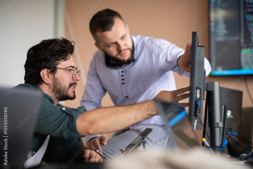 Programmers engrossed in deep collaboration, diligently working ...