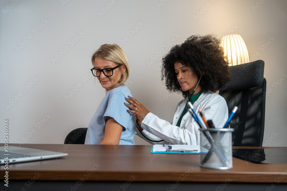 Female young aged doctor using stethoscope to examine patient. Patient ...
