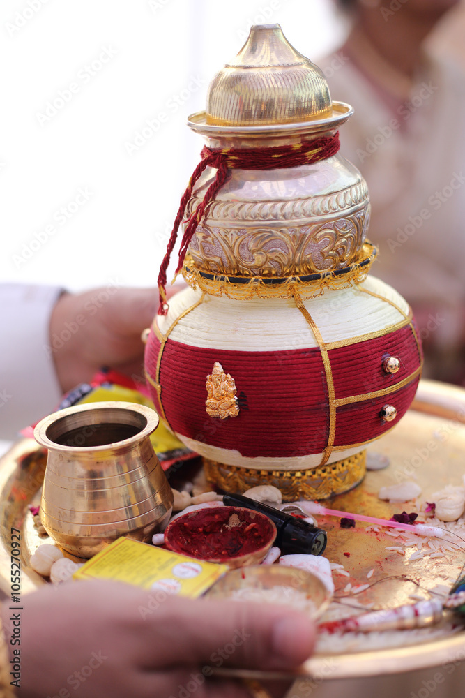 Traditional Indian kalash adorned with red and gold decorations ...