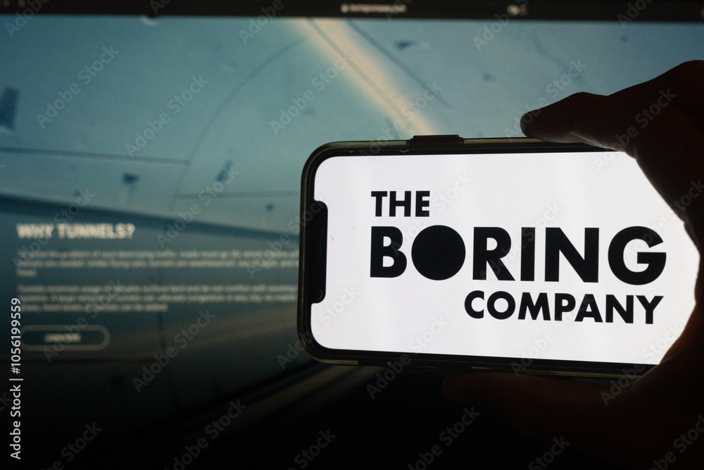 Silhouette of Hand Holding Phone with The Boring Company Logo in Front ...