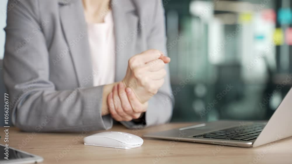 Close up. Female office worker holding wrist in pain while using ...