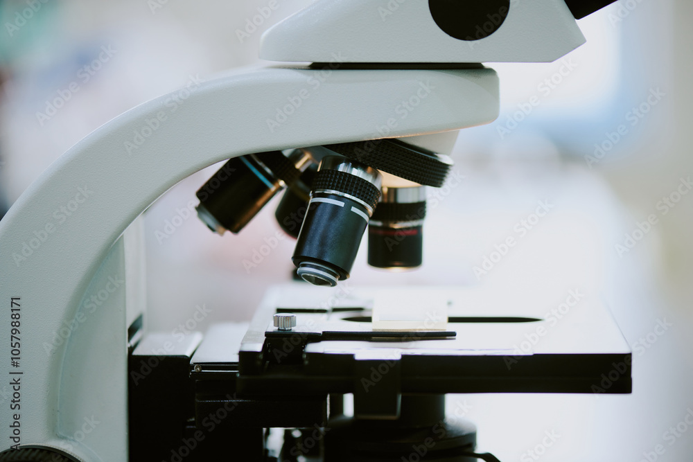 Poster Close-up of laboratory microscope focusing on sample slide ...