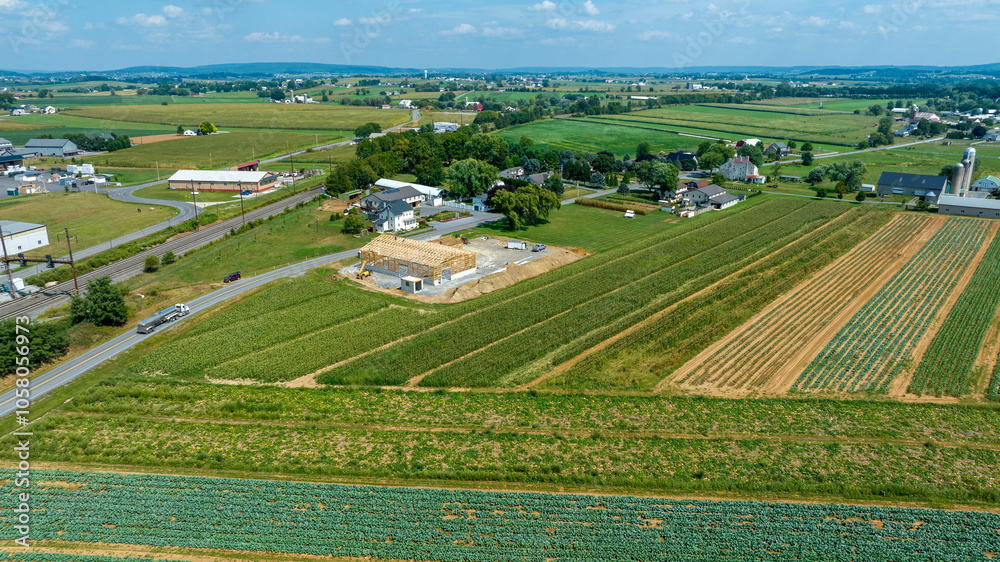 This aerial perspective captures a beautiful rural area featuring ...