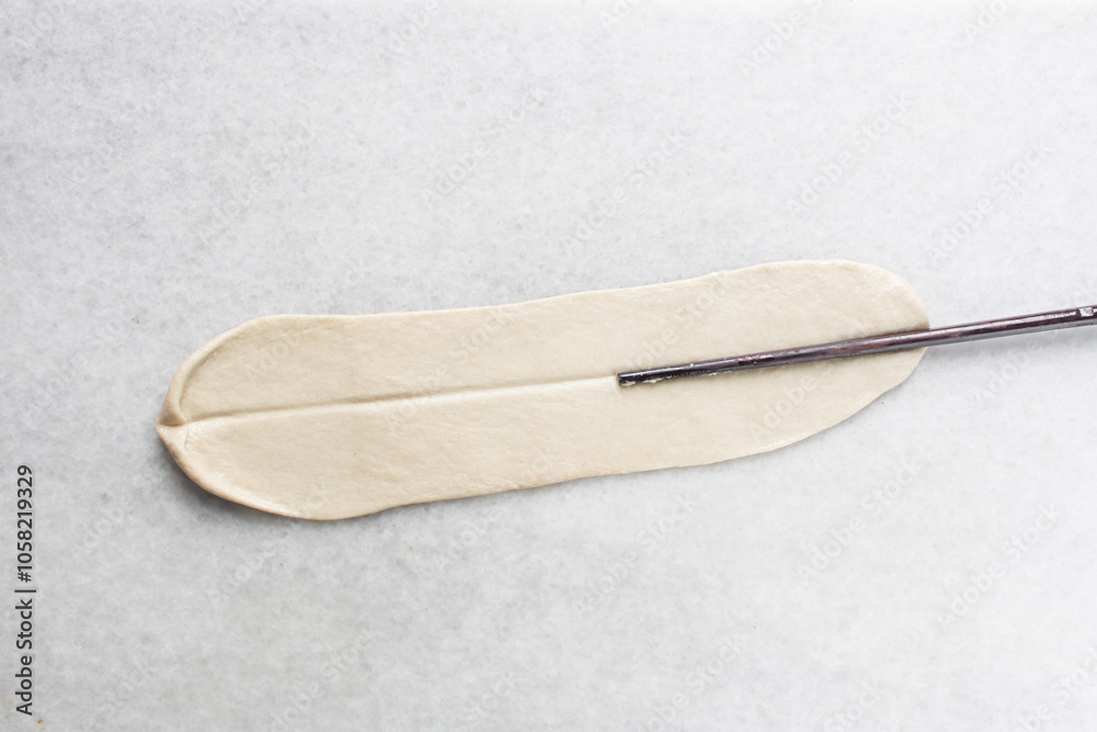 Overhead view of hand pulled noodles being stretched on a table, top ...