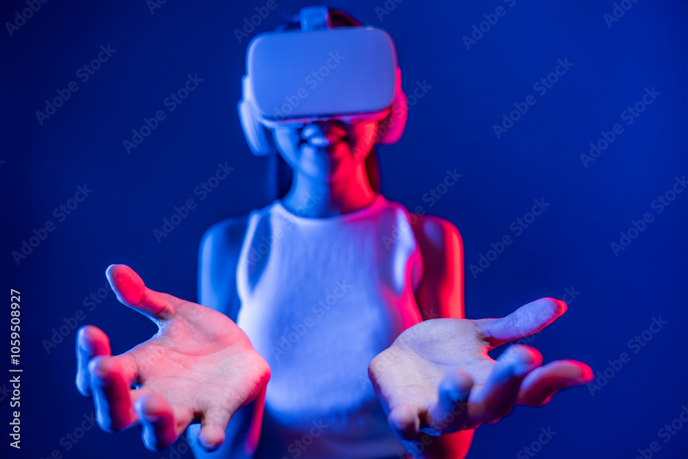 Smart Female standing surrounded by neon light wear VR headset ...