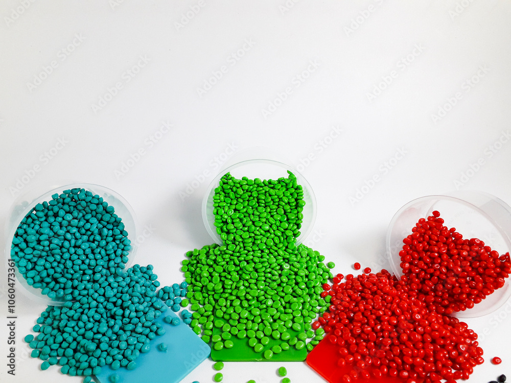Red, green and blue masterbatch granules are deposited on the color ...
