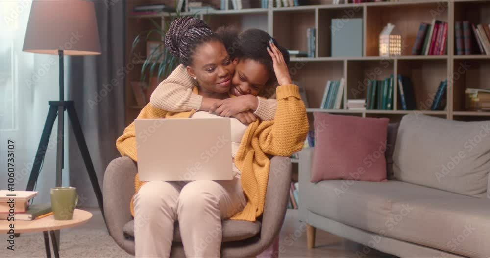 Young African American girl distracting mother from work. Approaching ...