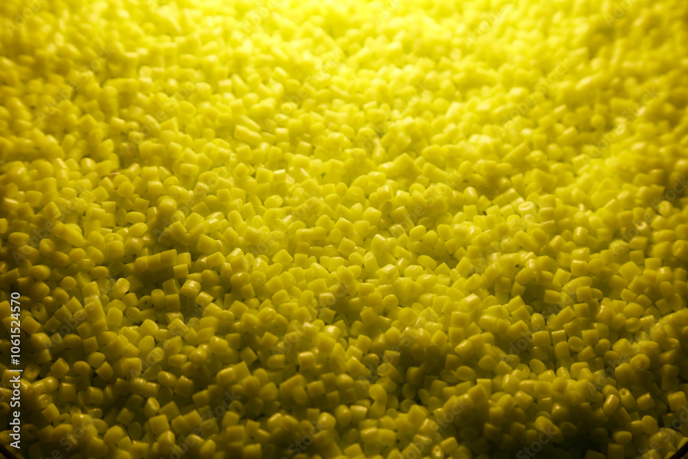 The pile of yellow pellets materials for plastic injection process. The ...
