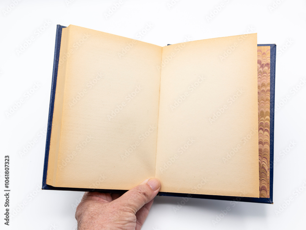 Libro abierto en blanco sujetado por una mano Stock Photo | Adobe Stock