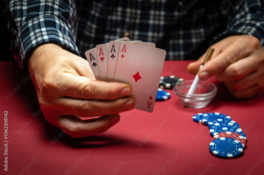 Playing cards in the hand of a gambler with a lucky combination of four ...