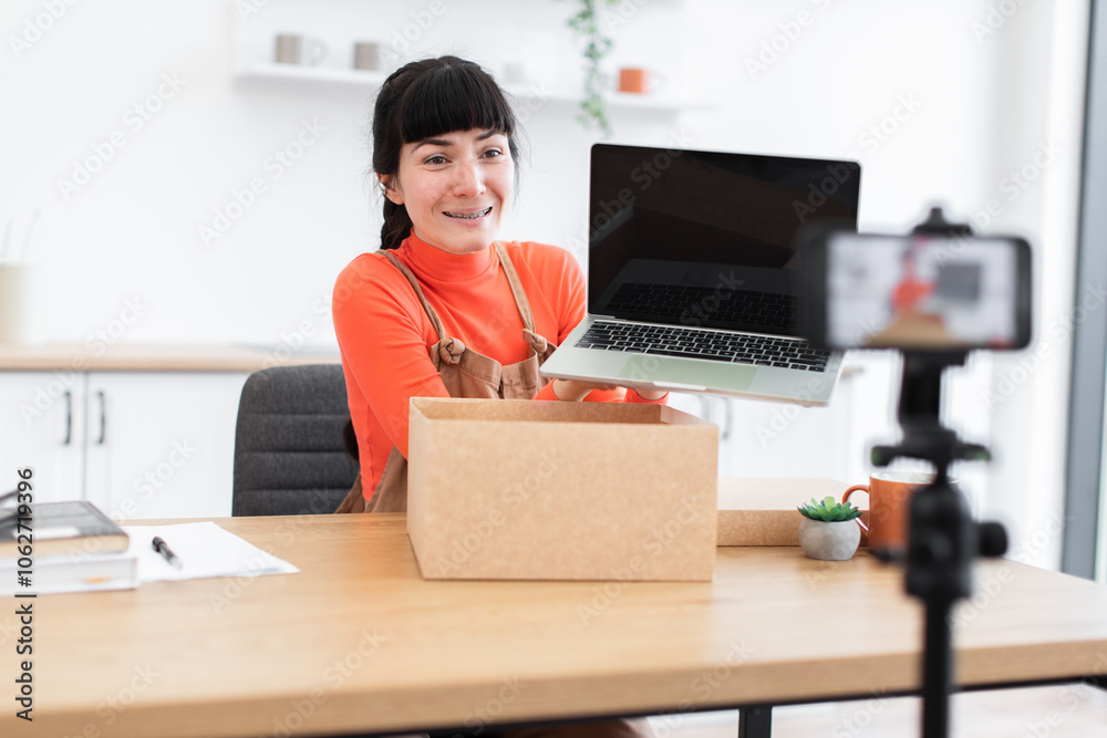 Caucasian young woman unboxing digital laptop in online video. Female ...