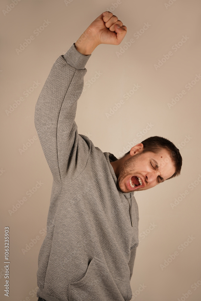 Man happy and excited with raised his hand up. Portrait of a cheerful ...