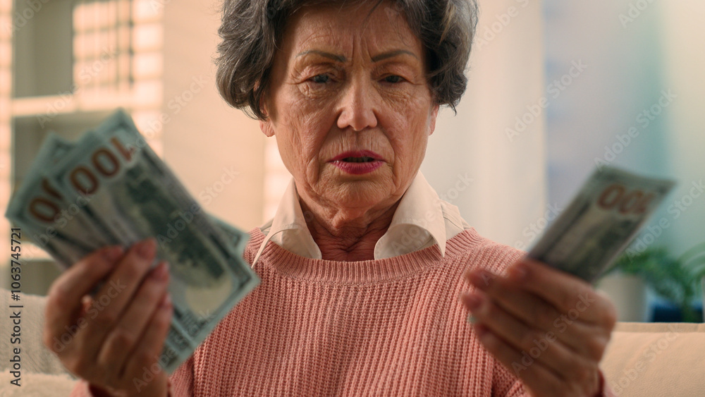 Sad dissatisfied stressed Caucasian old woman count money at home worry ...