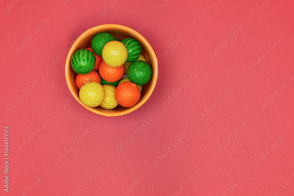 Chewing gum balls of different colors in shiny earthenware containers ...