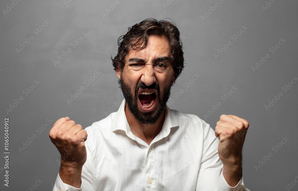 shouting aggressively with an angry expression or with fists clenched ...