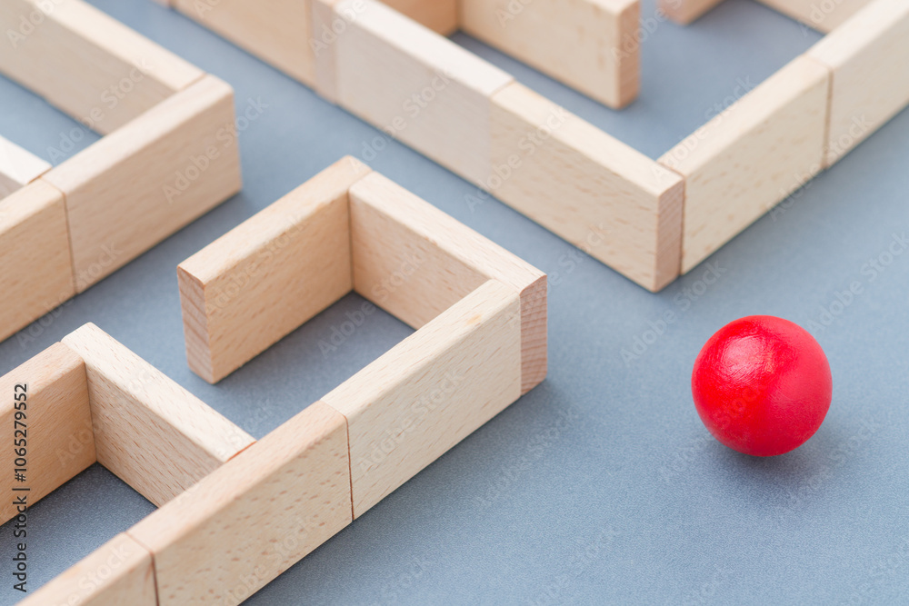 Red wooden ball at the entrance of the maze, stepping through the ...