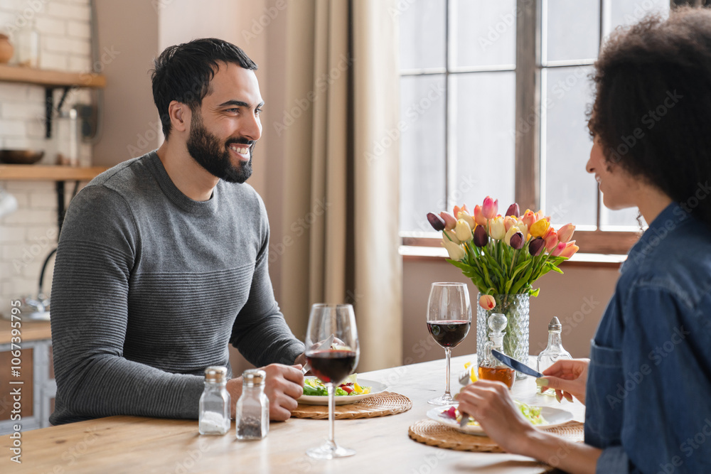 Mixed race couple having dinner to celebrate valentine's day together ...
