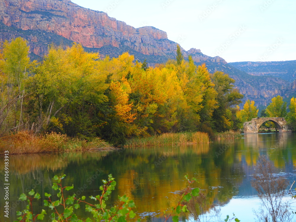 el río segre a su paso por la villa de camarasa rodeado de color otoñal ...