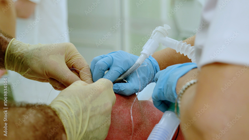 Medical team in sterile gloves collaborates in operating room with ...