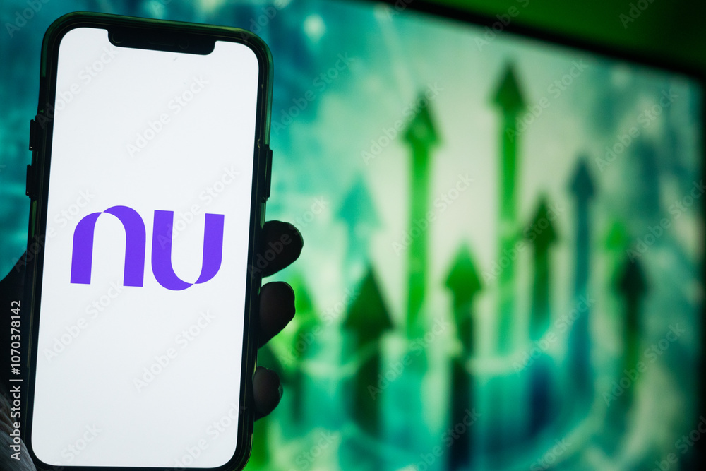 Hand Holding Phone with Nu Holdings (NU) Logo and Monitor in the ...