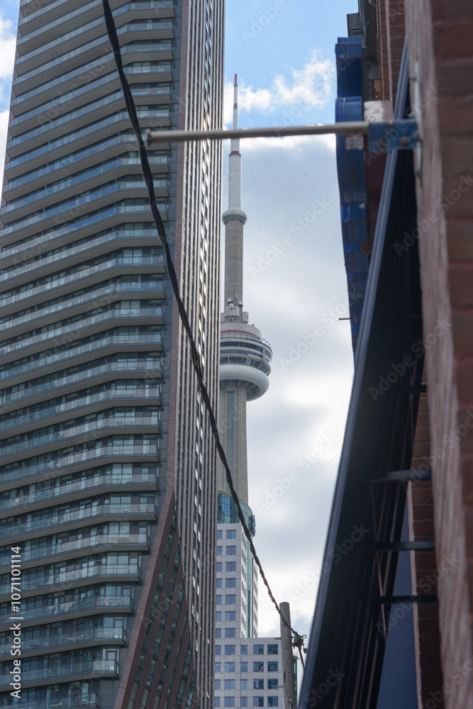 a partial view of the CN Tower with residential towers and a rather ...