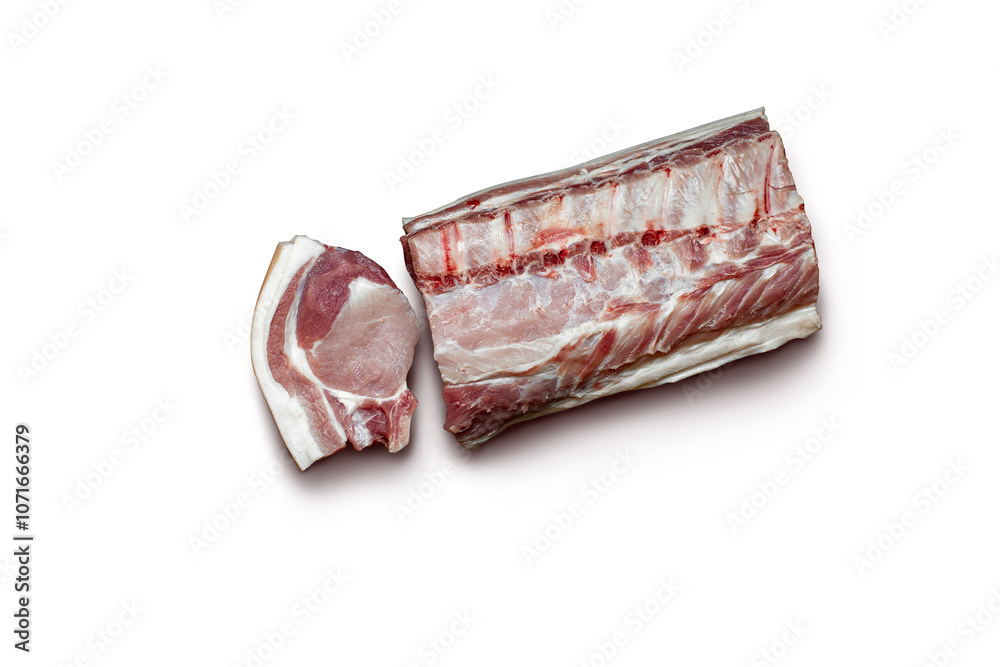 A raw pork rib rack with a single sliced portion displayed on a plain ...