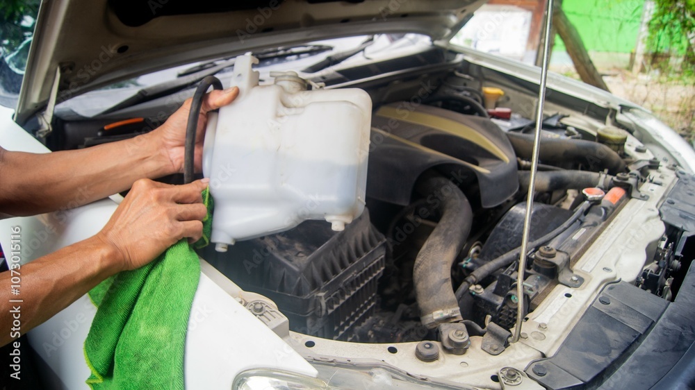 Cleaning the coolant storage tank for the car radiator that is damaged ...