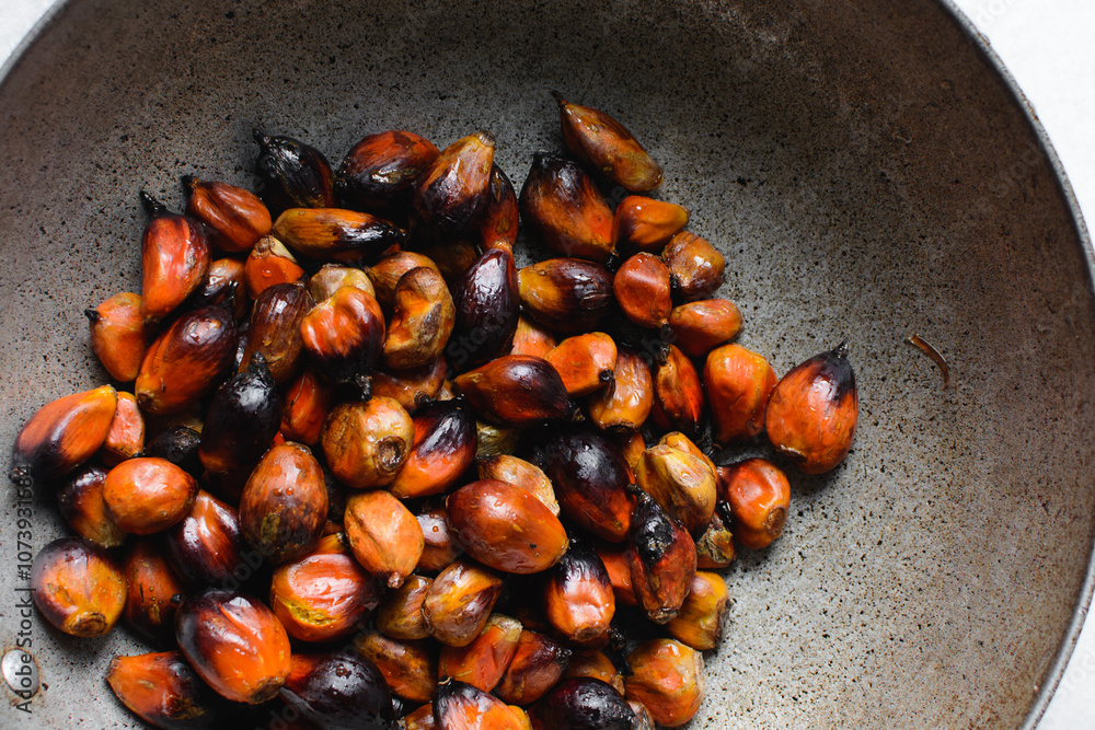 Overhead view of fresh palm nuts in a pot, top view of palm nuts for ...