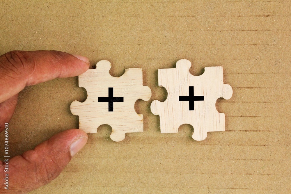 wooden puzzle with extra or plus symbols. plus signs are stacked up ...